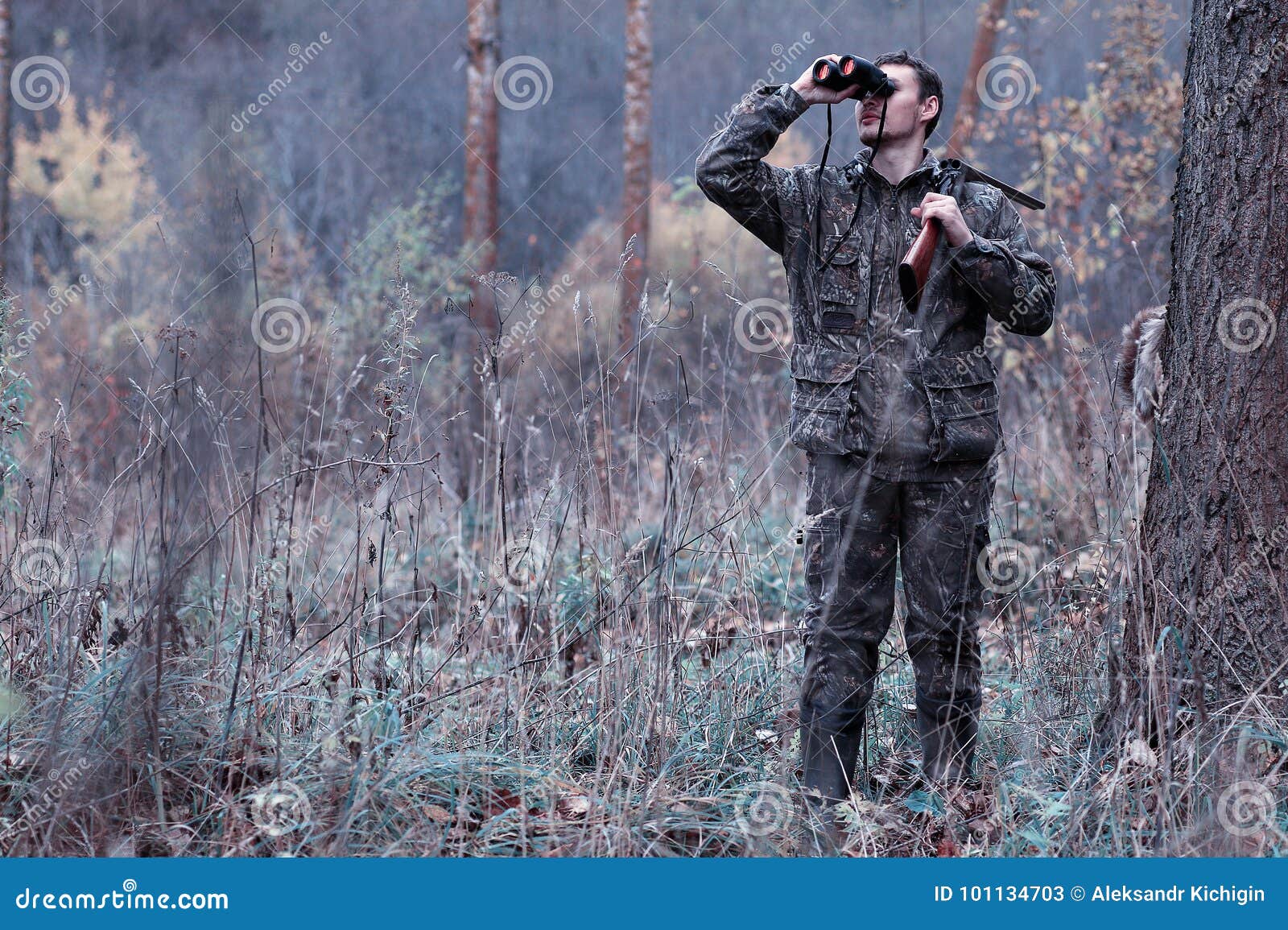 A Man in Camouflage and with a Hunting Rifle in a Forest on a Sp Stock ...