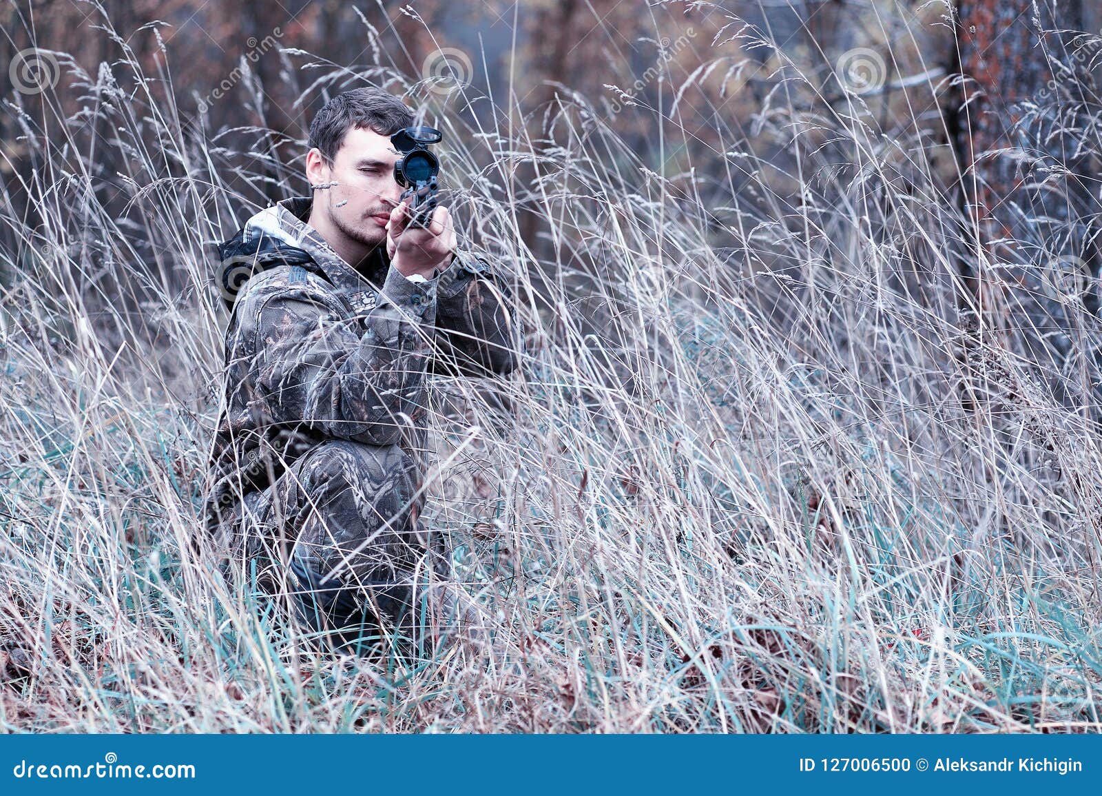 A Man in Camouflage and with a Hunting Rifle in a Forest on a Sp Stock ...