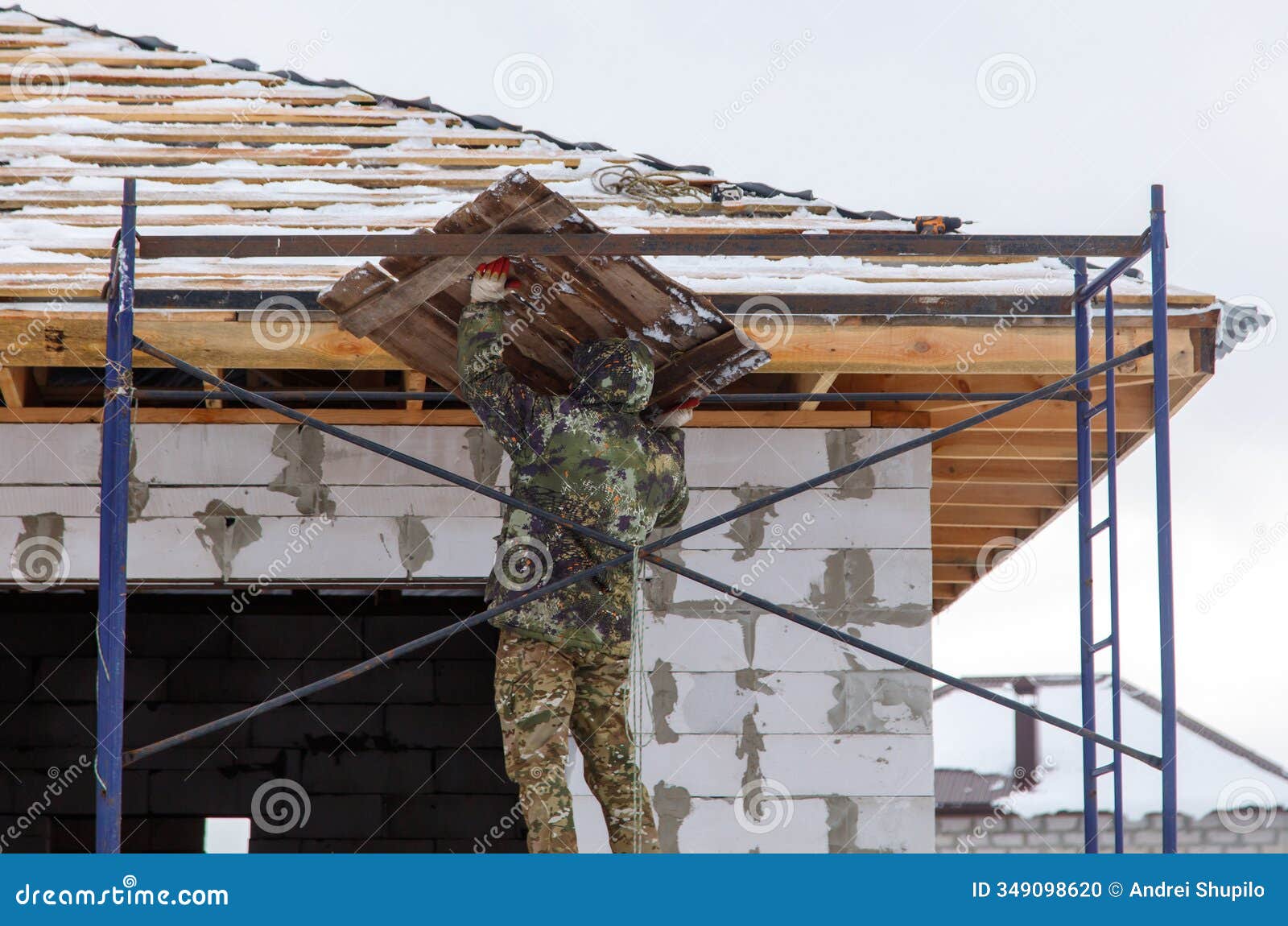 A Man in Camouflage is Working on a Roof Stock Photo - Image of repair ...