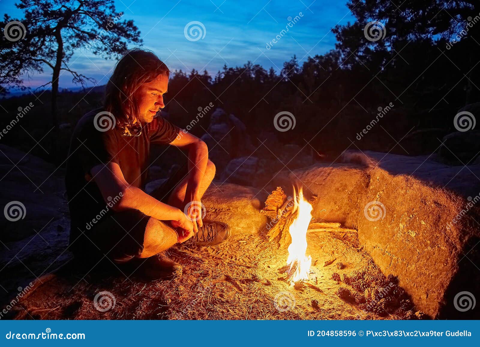 Man by a campfire stock photo. Image of camping, evening - 204858596