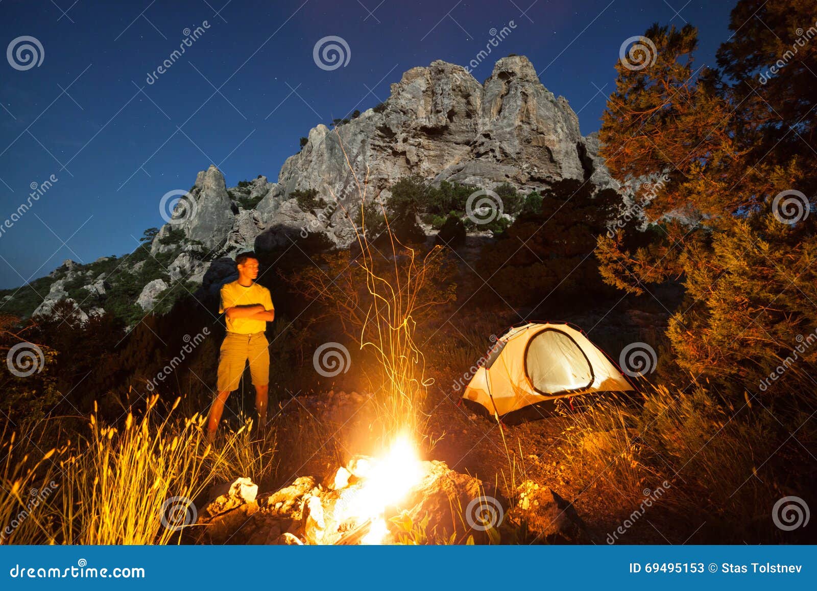 Man camping at night stock image. Image of outdoors, mountains - 69495153