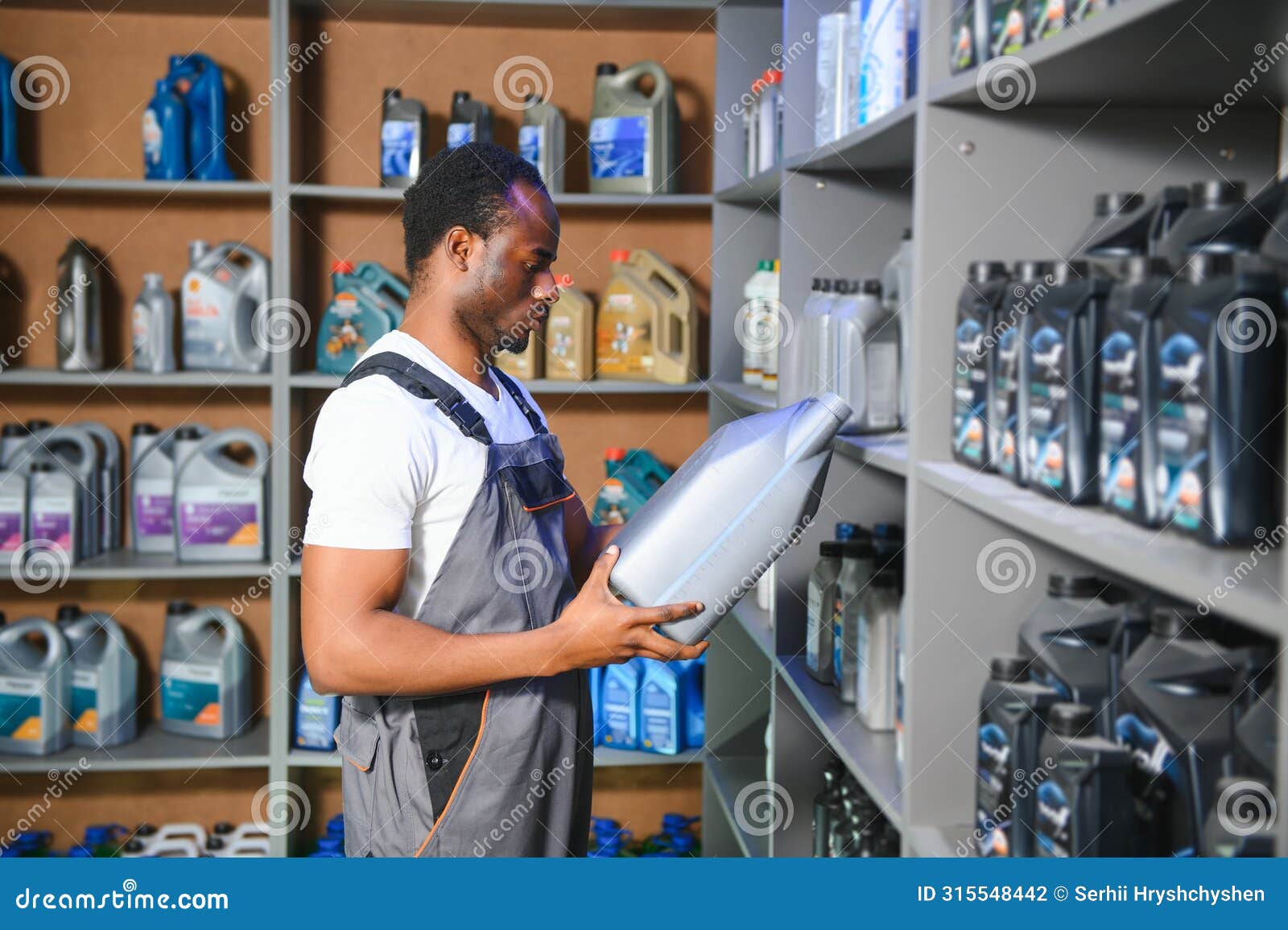 Man with Canister of Motor Oil in Auto Store Stock Photo - Image of ...