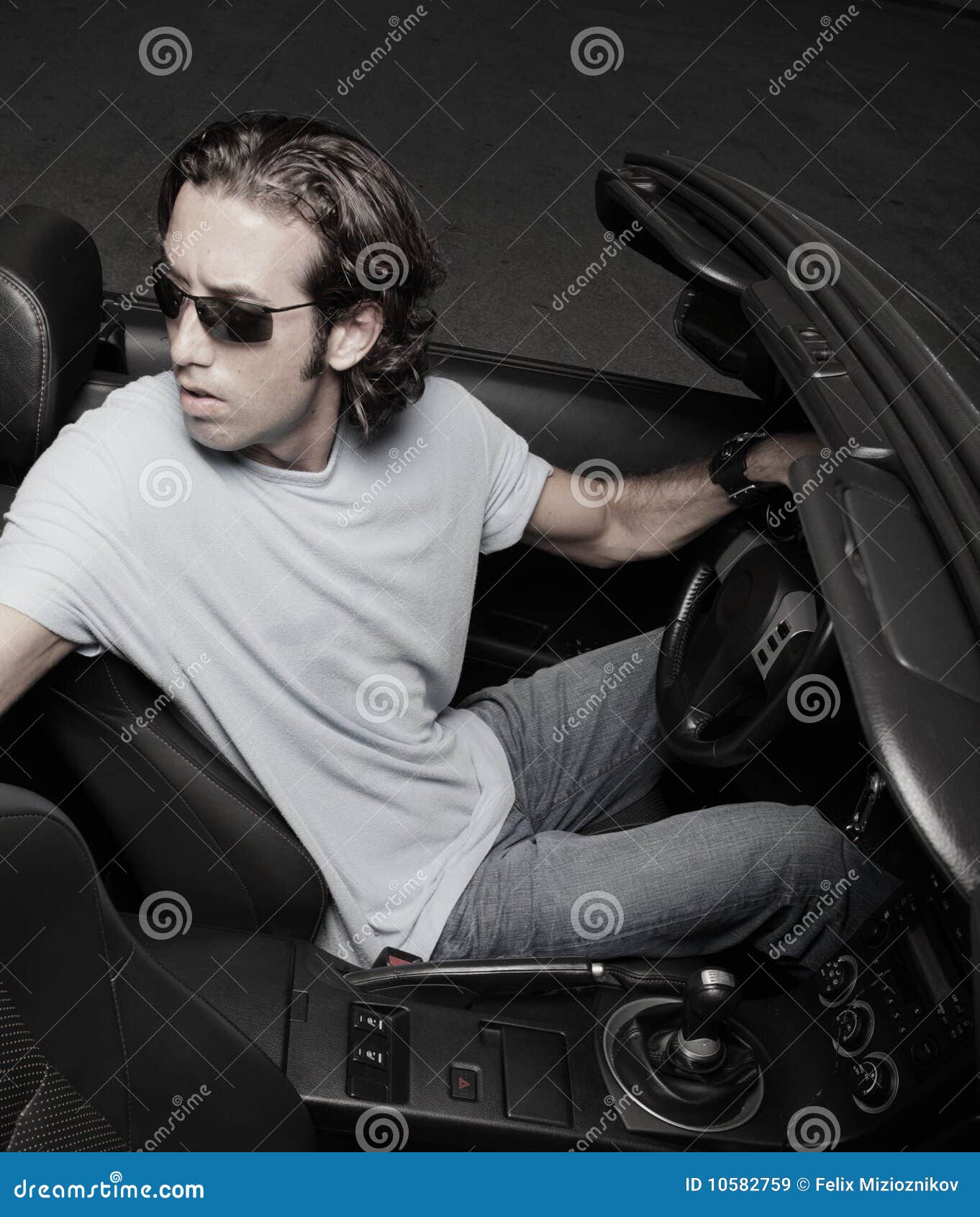 Man in a car backing up stock image. Image of male, handsome - 10582759