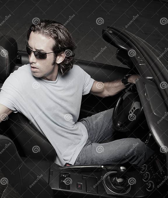 Man in a car backing up stock image. Image of male, handsome - 10582759