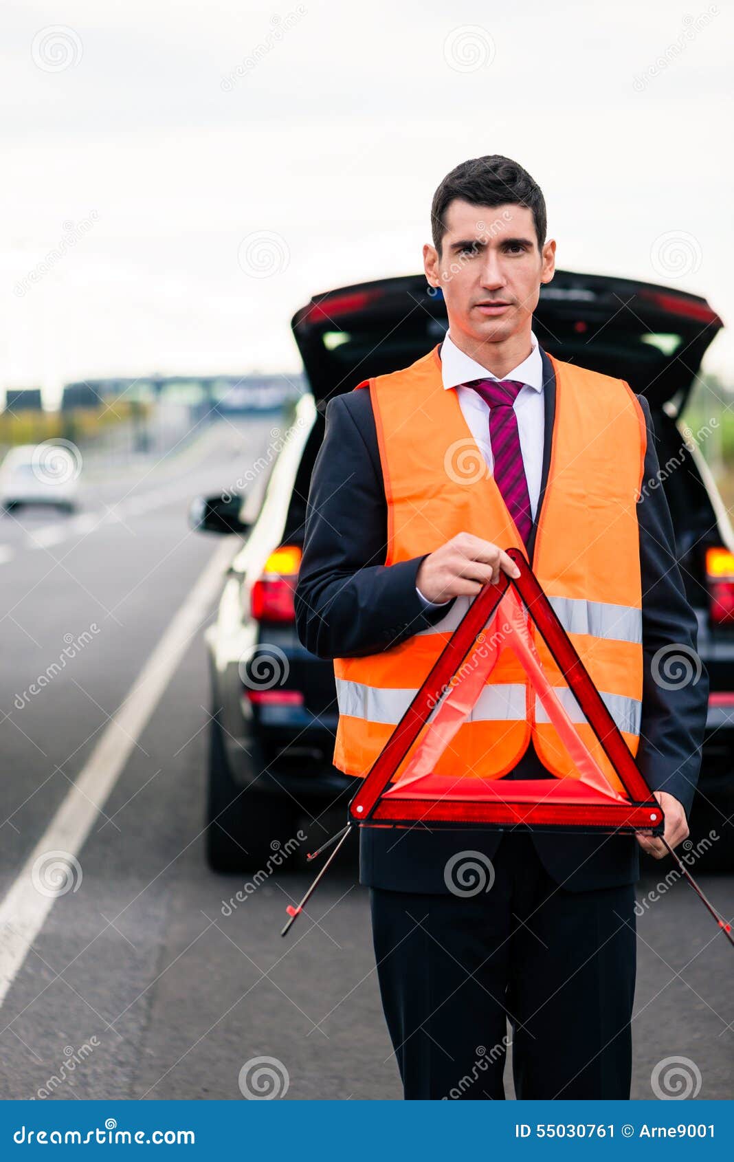 Man With Car Breakdown Erecting Warning Triangle Royalty-Free Stock ...