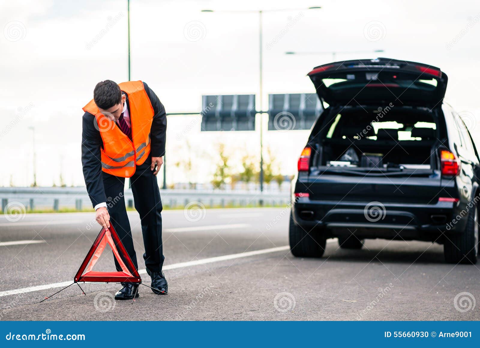 Man With Car Breakdown Erecting Warning Triangle Royalty-Free Stock ...