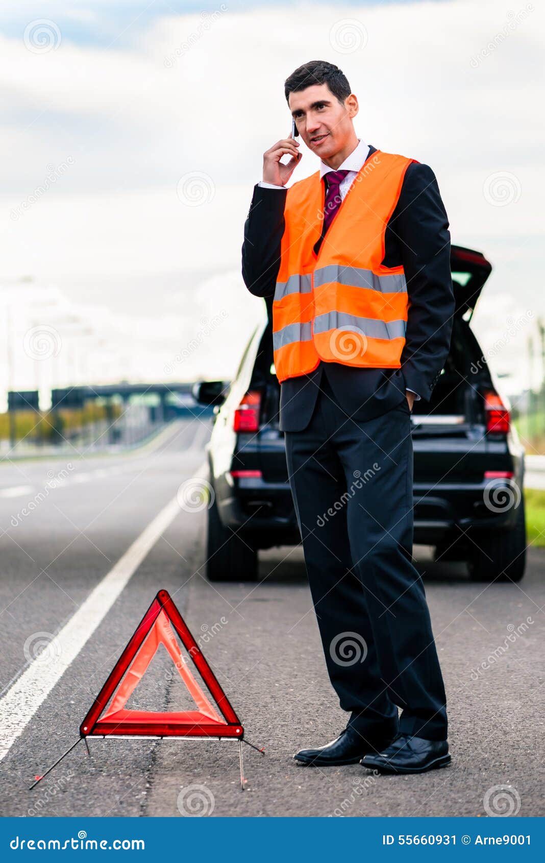 Man With Car Breakdown Erecting Warning Triangle Stock Image ...