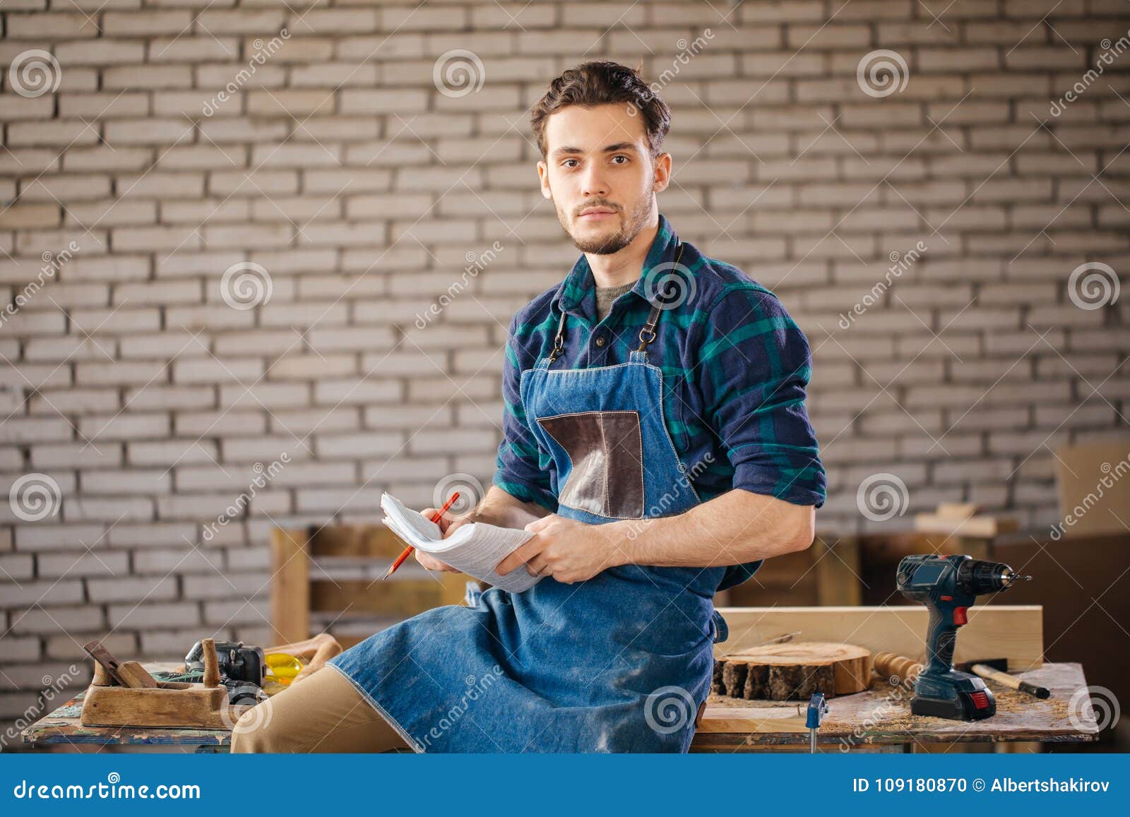 Man Carpenter in His Home Studio Draws Sketches in Pencil in Notebook ...