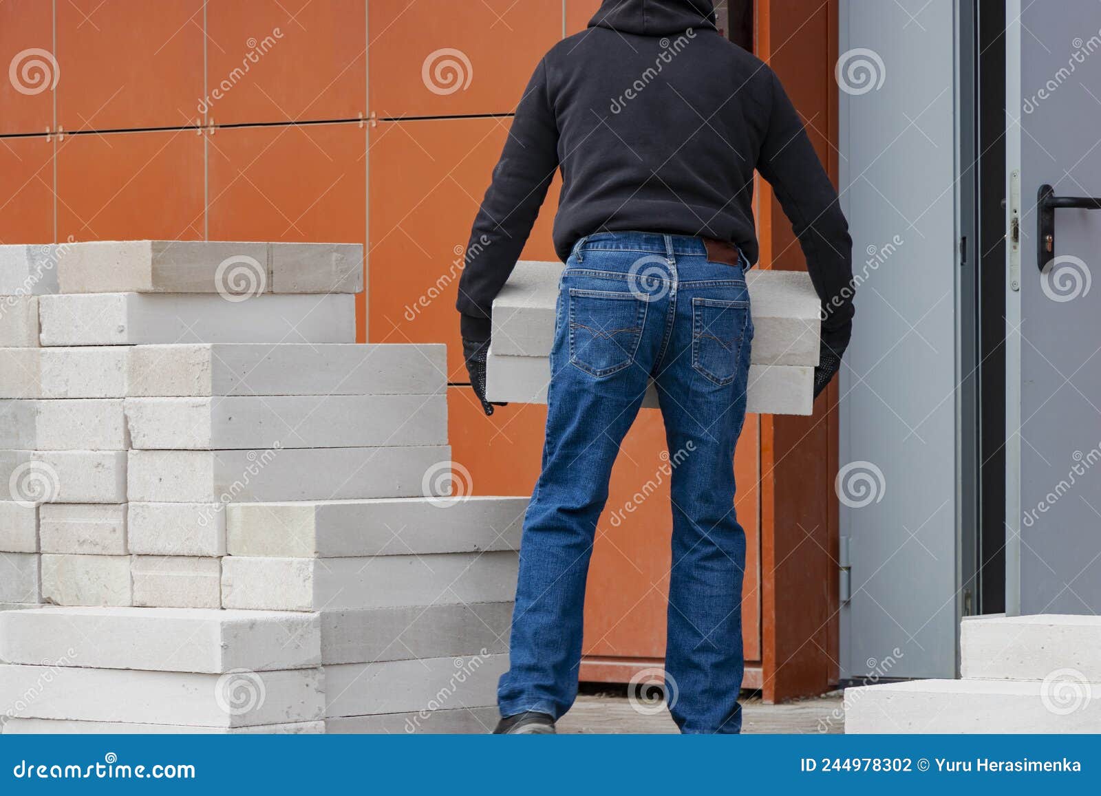 A Man Carries Foam Concrete Blocks To the Construction Site, Preparing ...