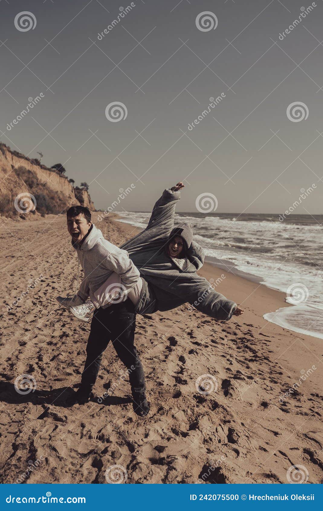 Man Carries His Girlfriend On Back Couple Having Fun On The Seashore