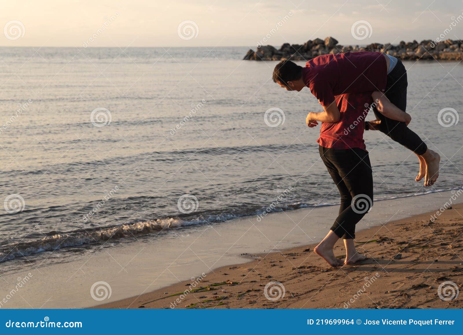 Man carrying another man stock photo. Image of couple - 219699964