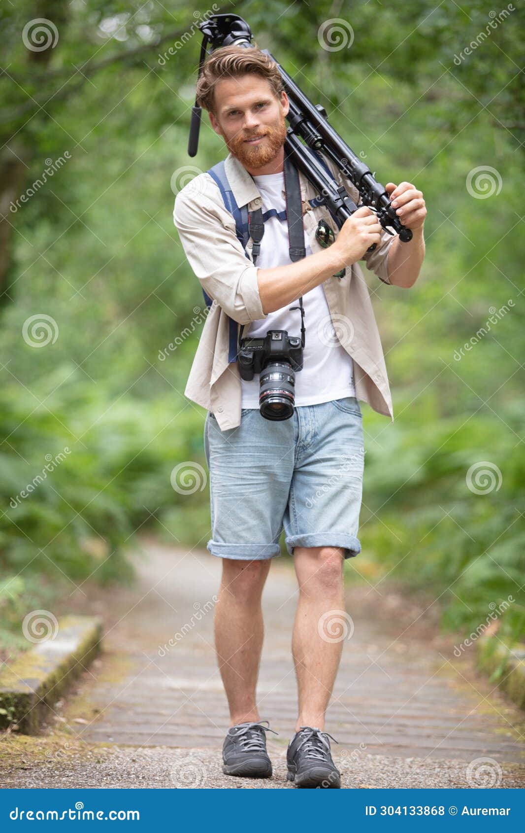 Man Carrying Camera and Tripod Stock Photo - Image of shot, tripod ...