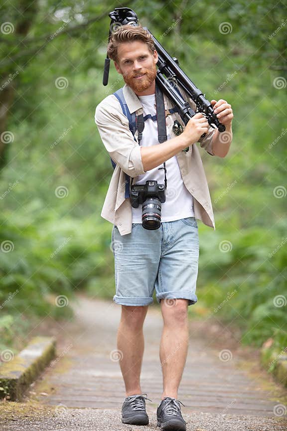 Man Carrying Camera and Tripod Stock Photo - Image of shot, tripod ...