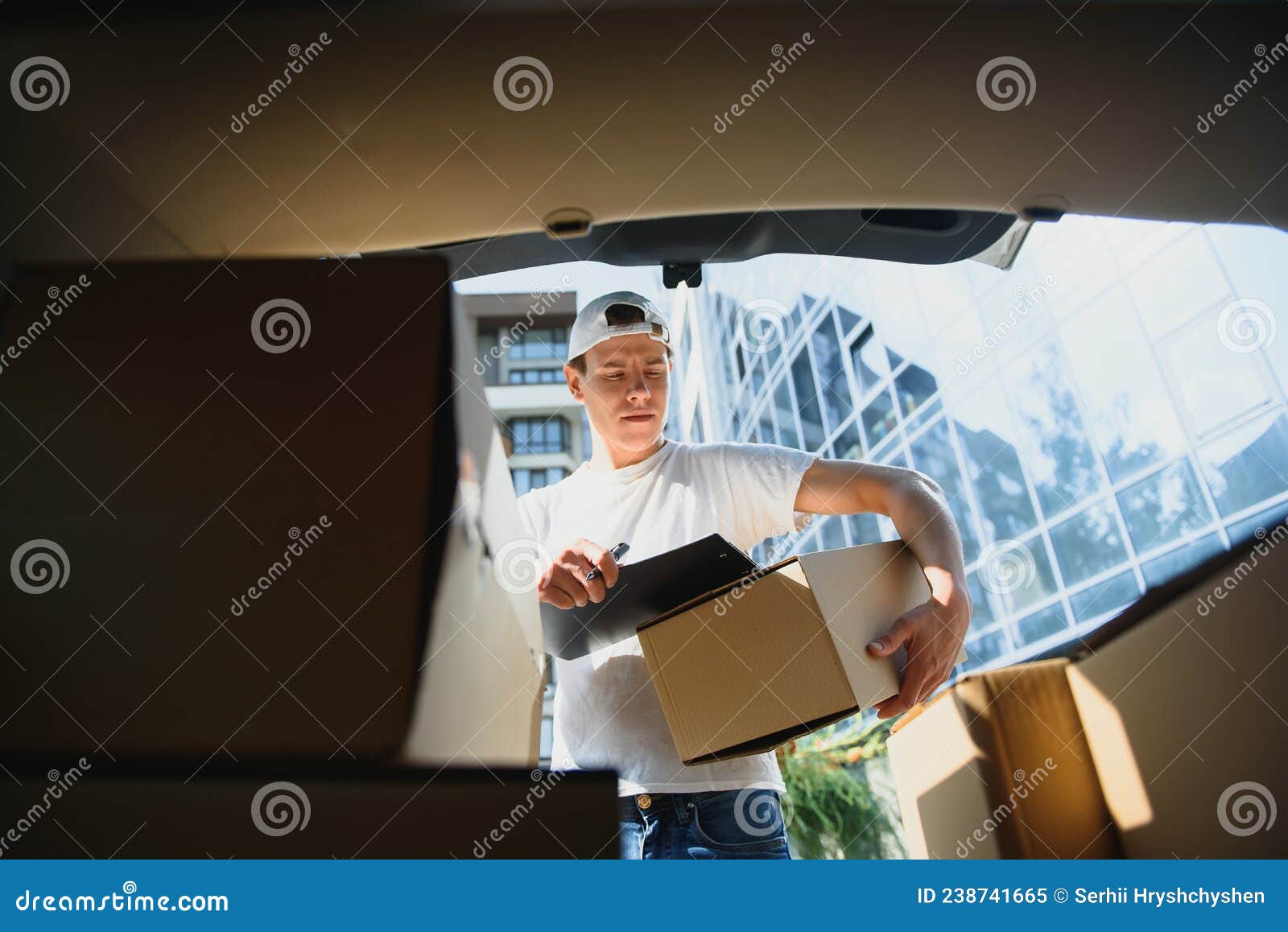 A Man Carrying Package from Delivery Car - Courier Service Concept ...