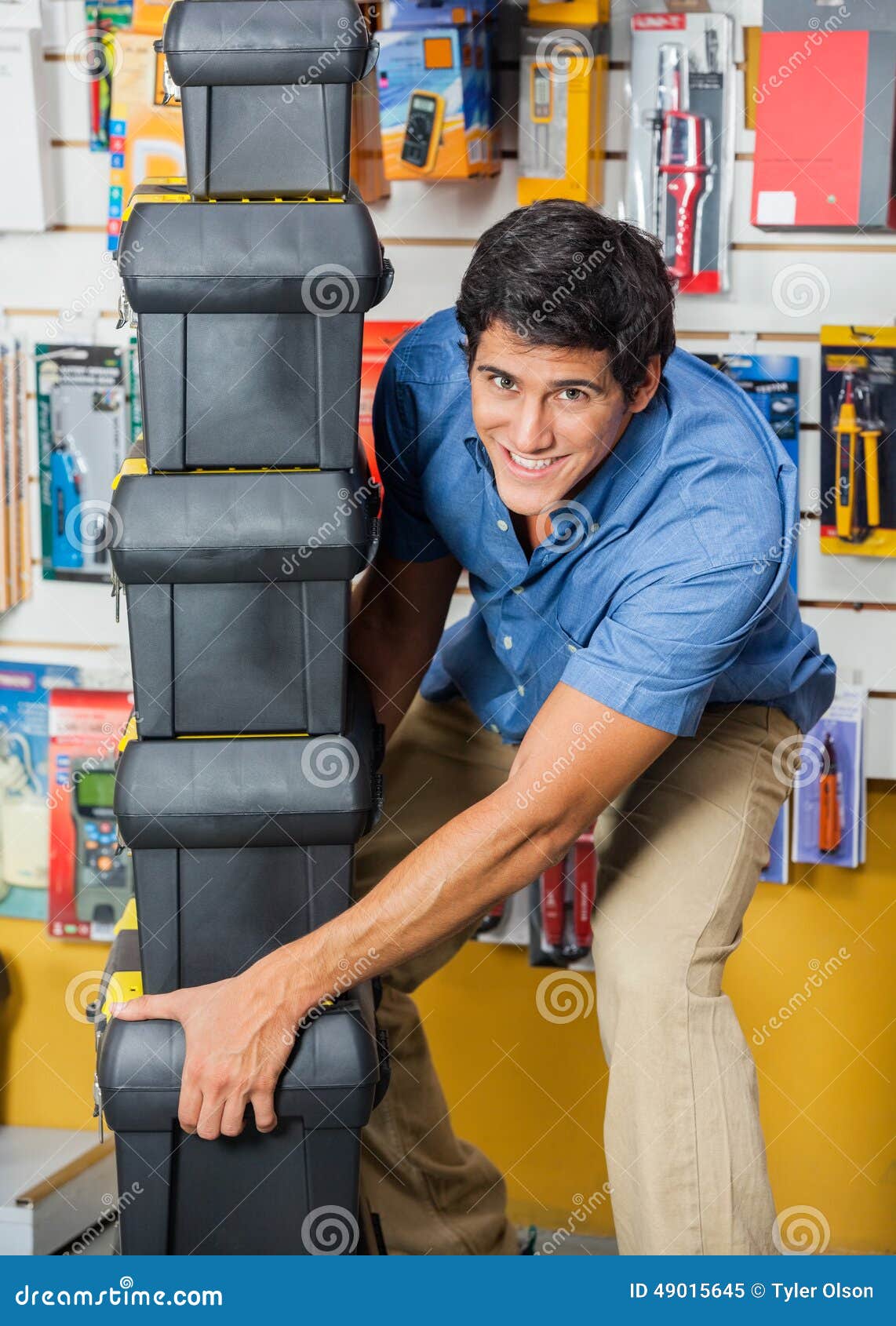 Man Carrying Stacked Toolboxes in Hardware Store Stock Image - Image of ...