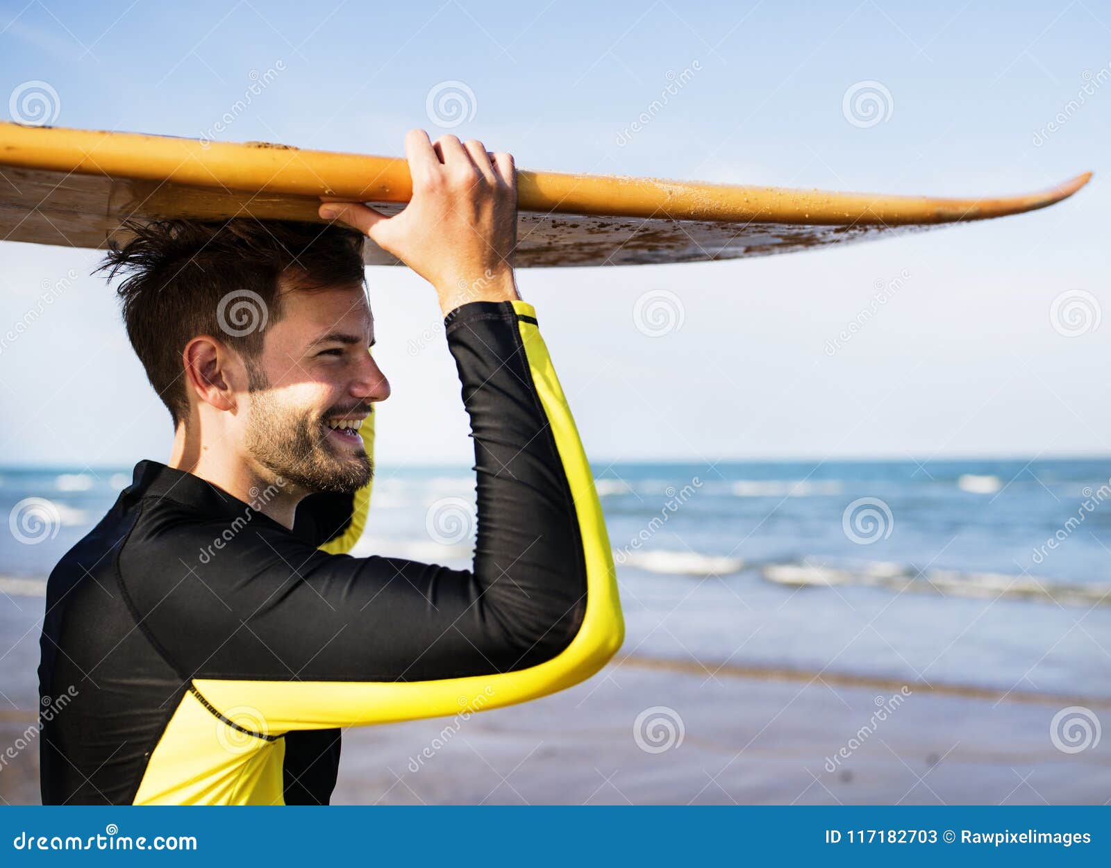 A man carrying a surfboard stock image. Image of sports - 117182703