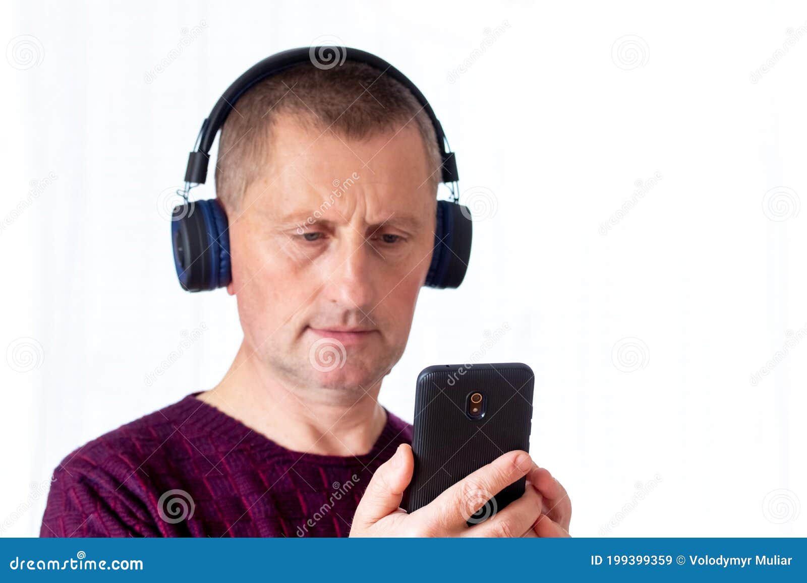 Man with Cell Phone and Wireless Headphones Stock Image - Image of ...