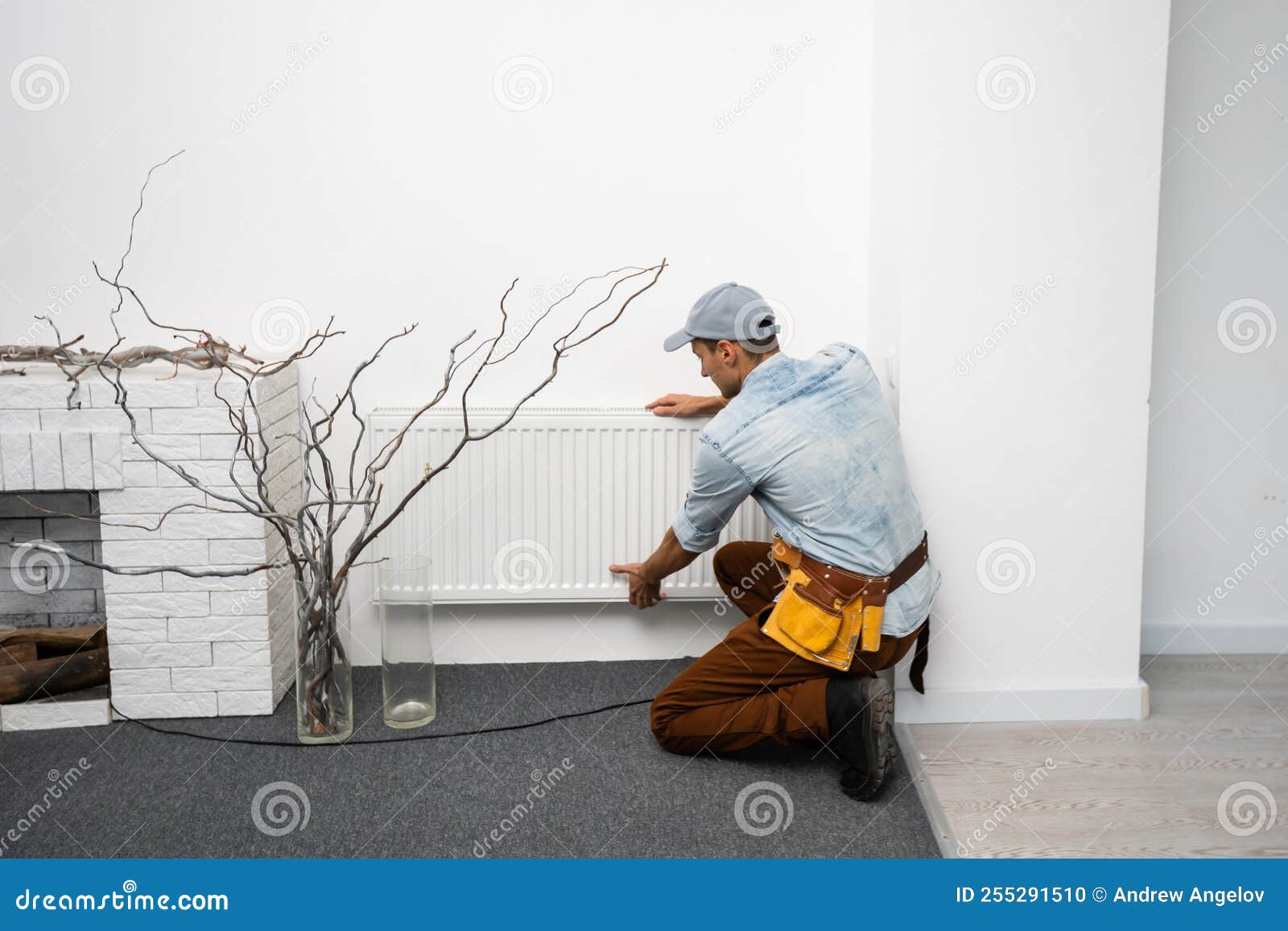 A Man Changes the Heating in the House, Radiators. the Concept of ...