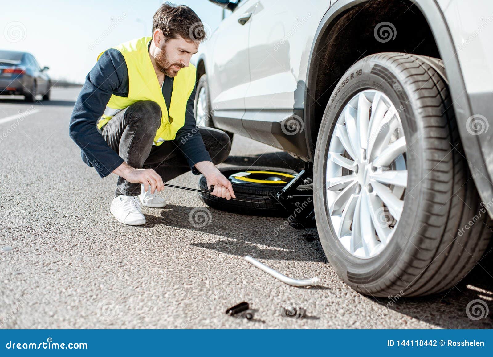 Man Changing Car Wheel on the Roadside Stock Photo - Image of ...
