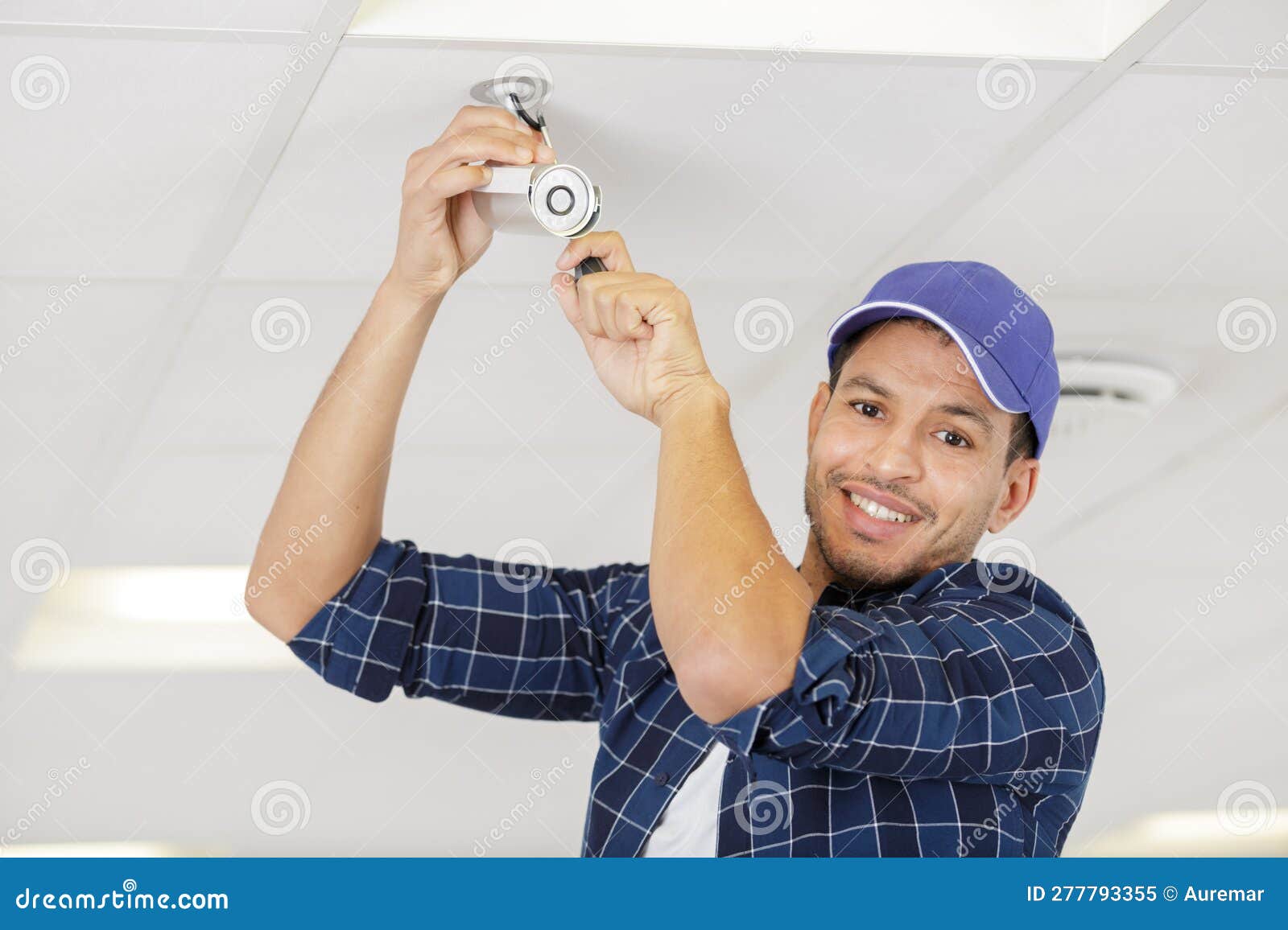 Man Changing Ceiling Light Bulb Stock Image - Image of handyman, young ...