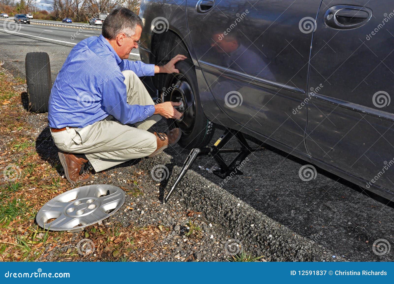 Man Changing Flat Tire Royalty Free Stock Photography - Image: 12591837
