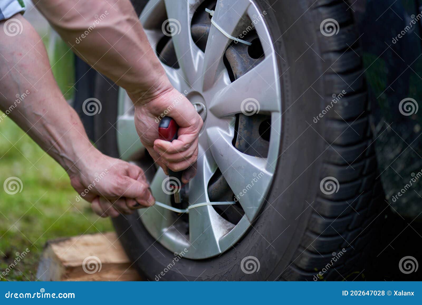 Man changing a flat tyre stock photo. Image of travel - 202647028