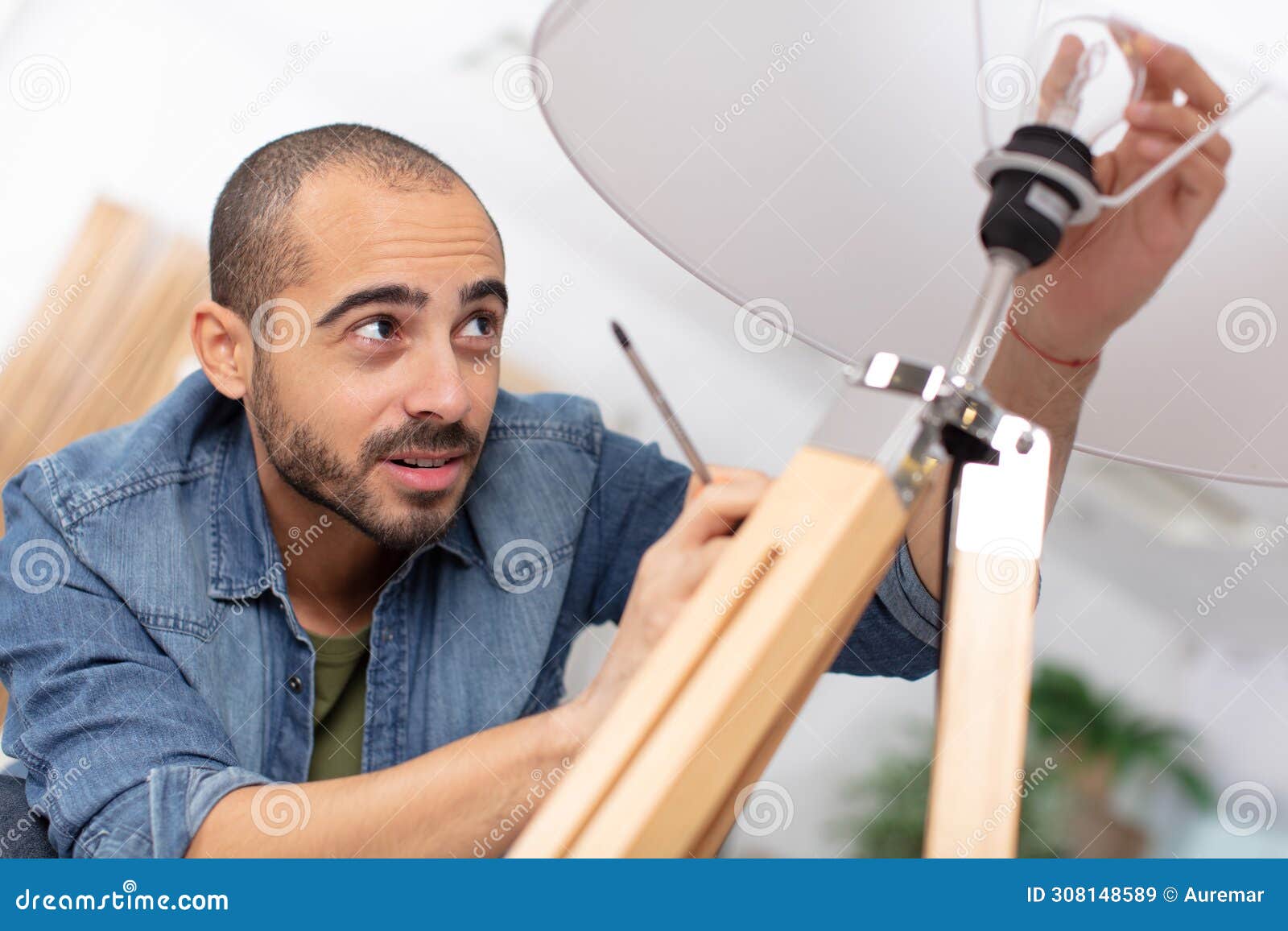Man Changing Light Bulb in Lamp at Home Stock Image - Image of ...