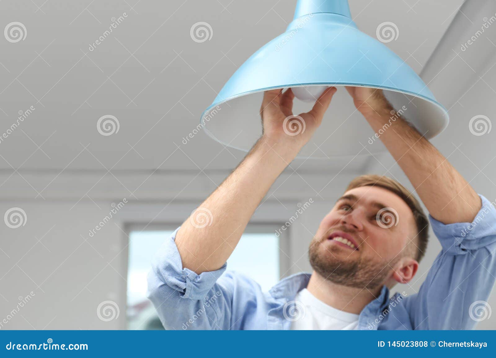 Man Changing Light Bulb in Lamp Stock Photo - Image of caucasian ...