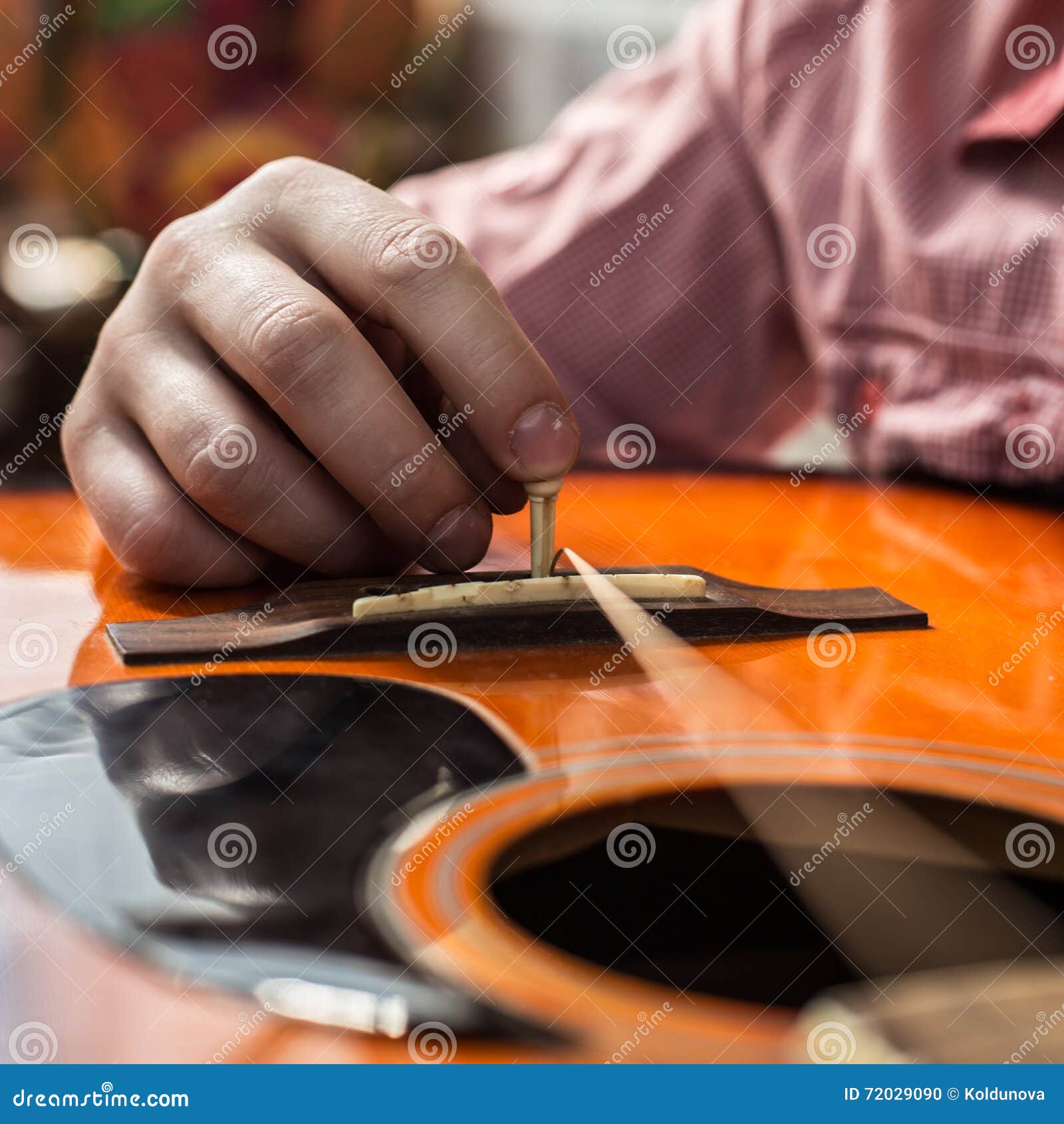 A Man Changing Old Ripped Guitar Strings on the Acoustic Guitar Stock ...