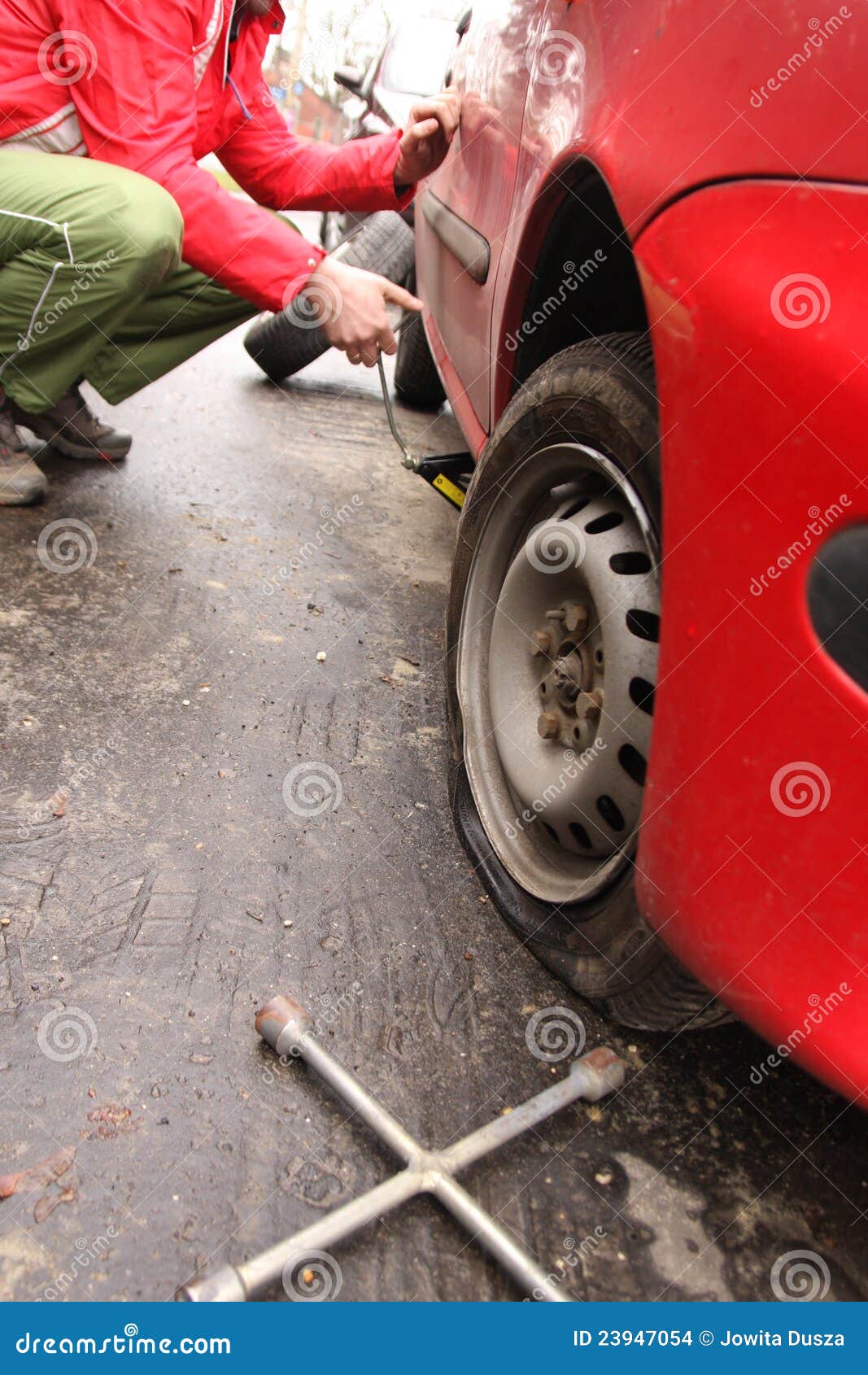 Man Changing a Tire on the Street Stock Photo - Image of person ...