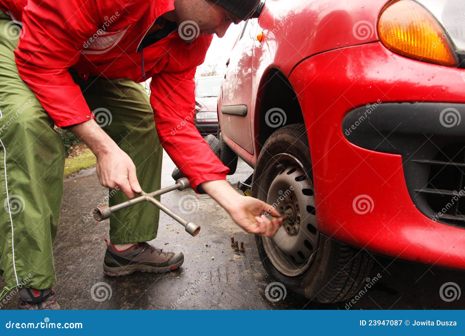 Man Changing a Tire on the Street Stock Image - Image of tire, person ...