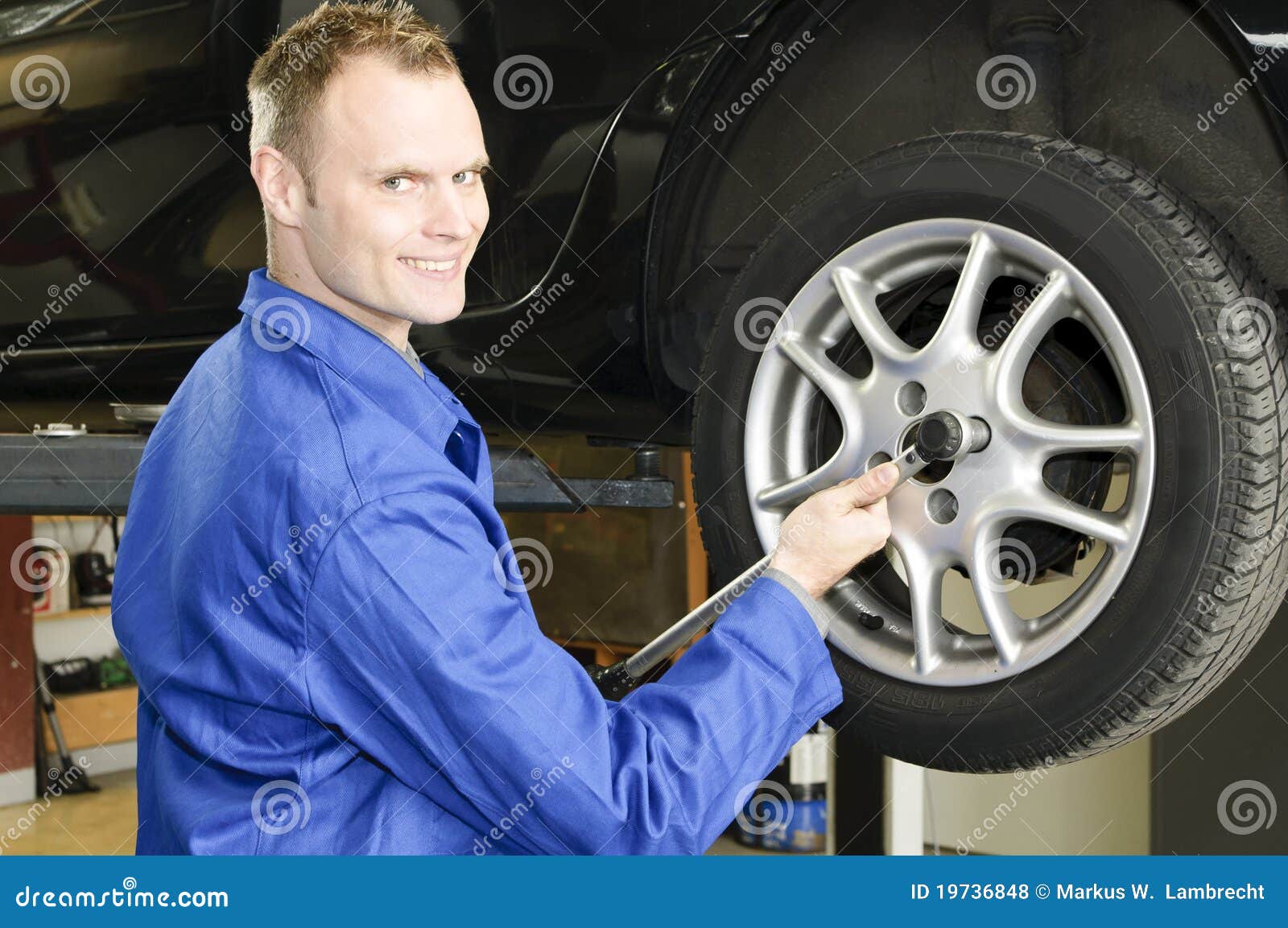 Man Changing Tires in the Garage Stock Photo - Image of caucasian ...