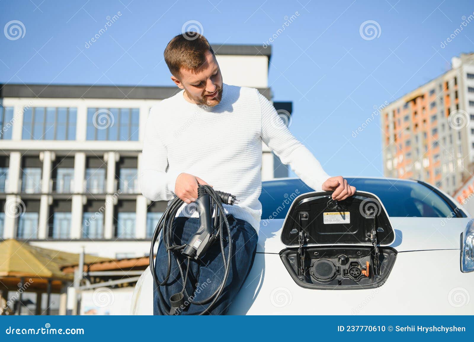 Man Charges an Electric Car at the Charging Station Stock Photo - Image ...