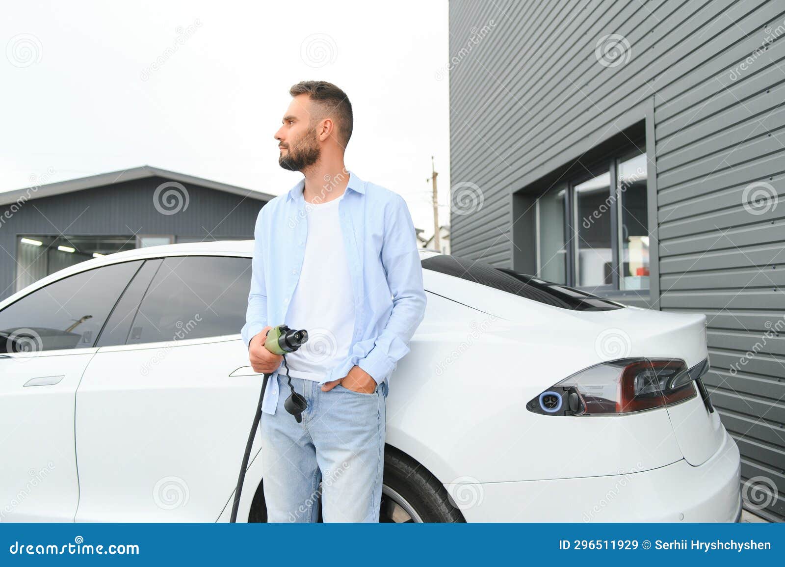 Man Charging Electric Car by the House. Stock Image - Image of power ...