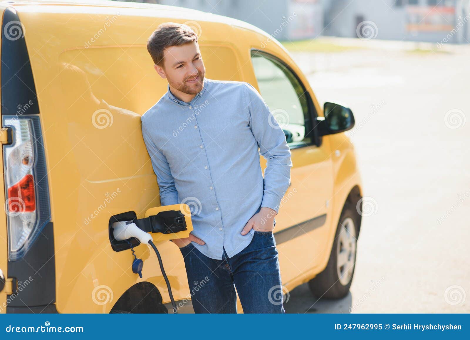 Man Charging Electric Vehicle with Cable Stock Image - Image of ...