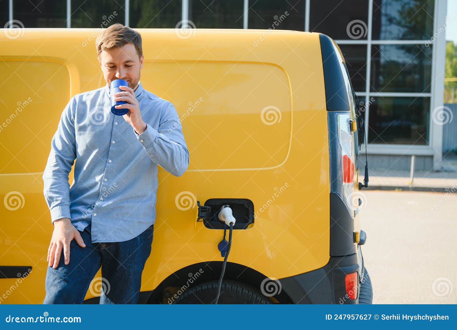 Man Charging His Electric Car at Charge Station. Stock Image - Image of ...