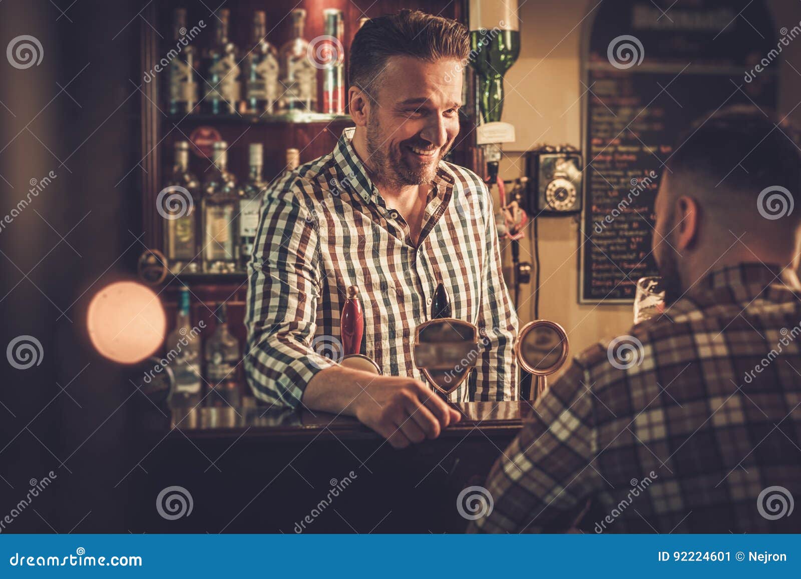 Man Chatting with a Bartender in a Pub Stock Image - Image of beer ...