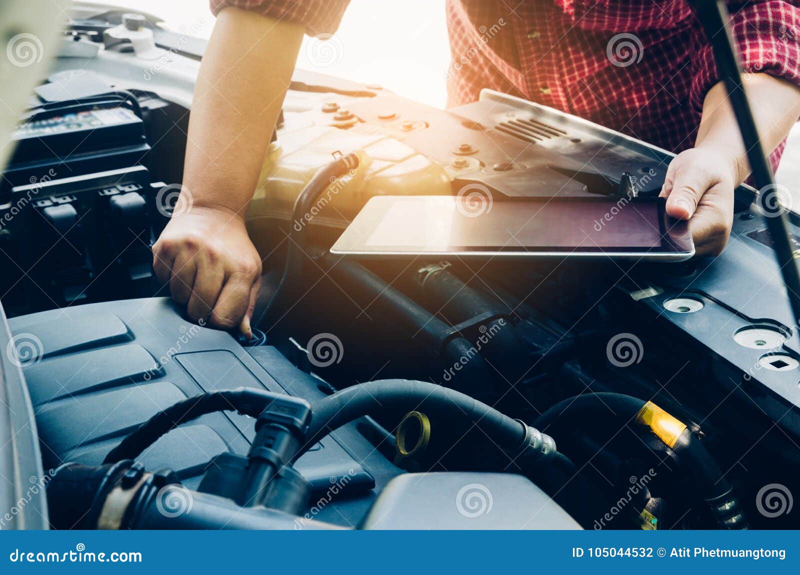 Man Checking on a Car Engine and Hold Tablet Search for Data Stock ...