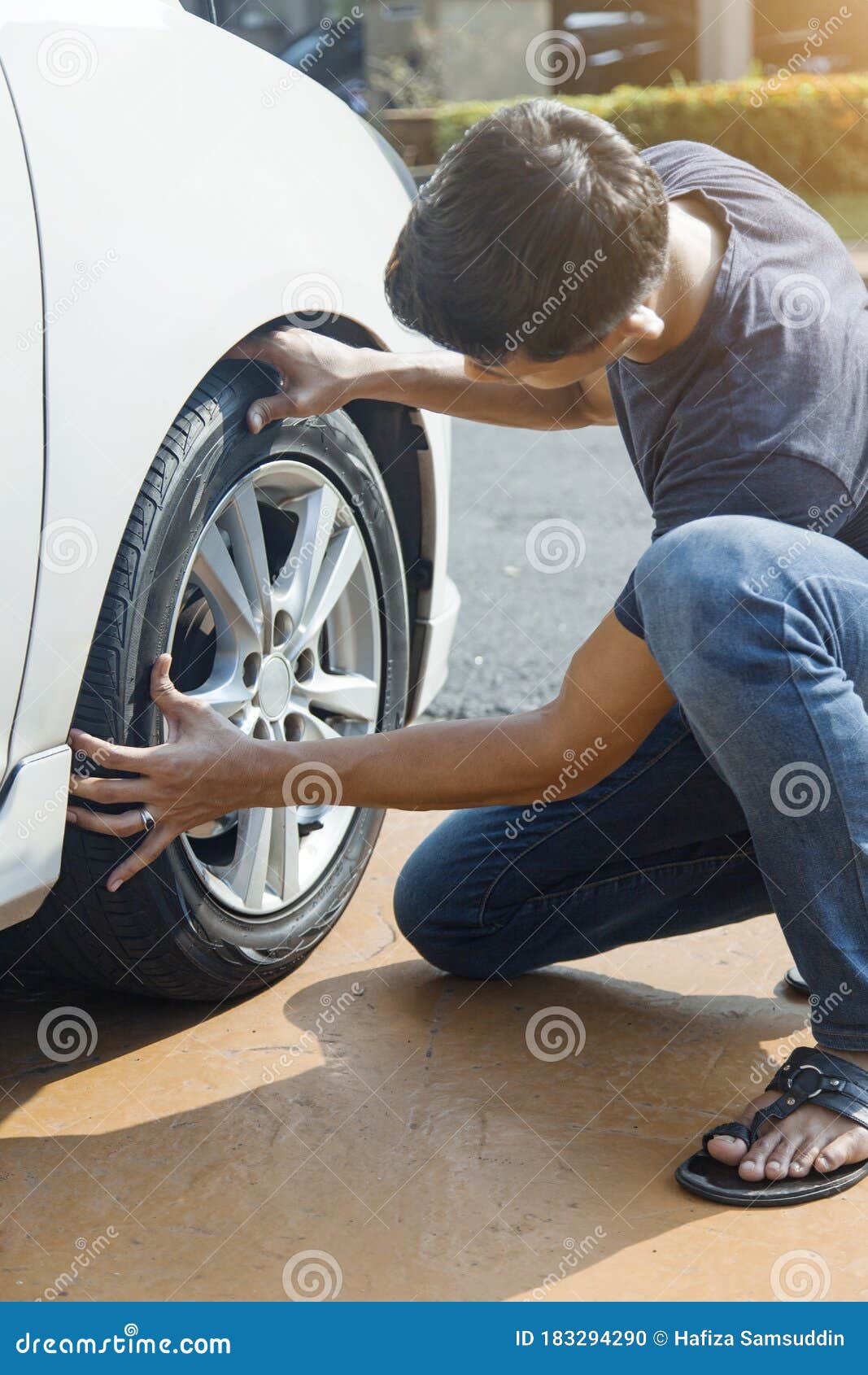 Man checking car tire stock photo. Image of checking - 183294290