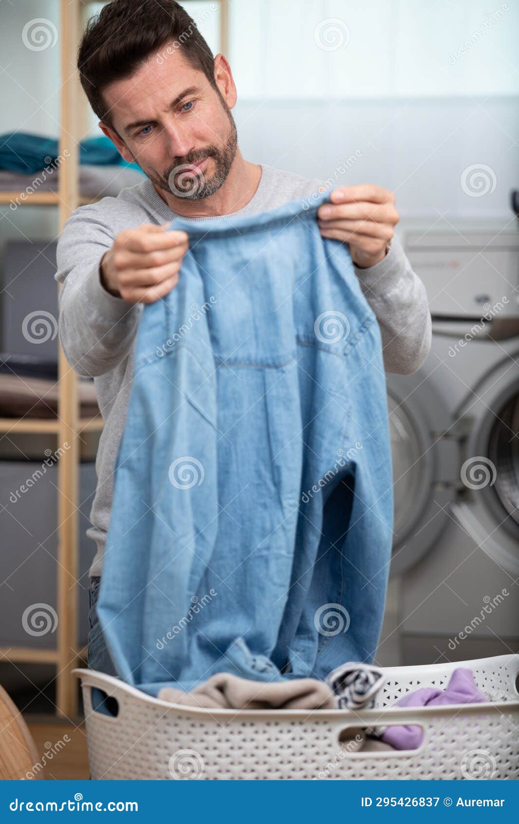 Man Checking Cleanliness Laundry Stock Image - Image of checking, adult ...