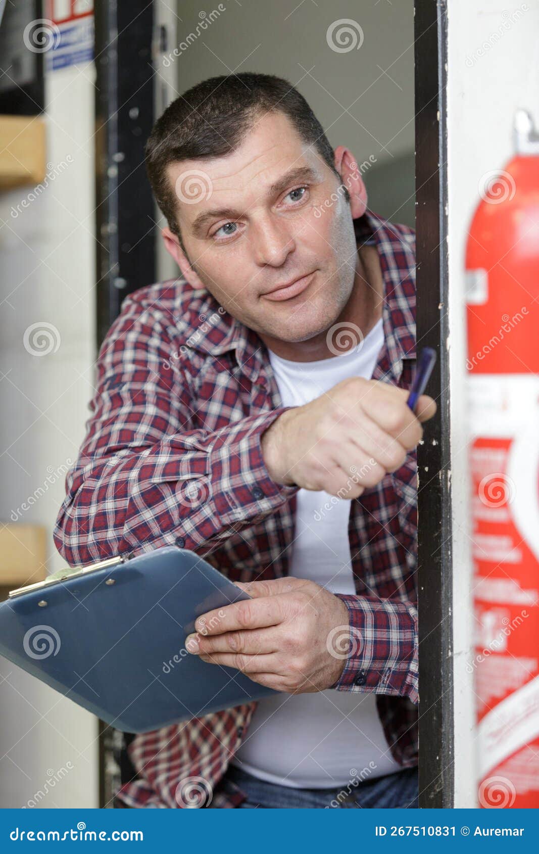 Man Checking Fire Extinguisher Writing on Document Stock Image - Image ...