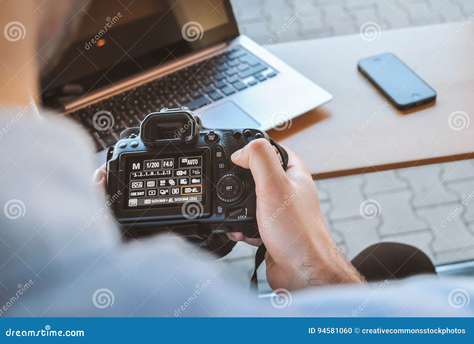A Man Checking His Camera Settings Picture. Image: 94581060