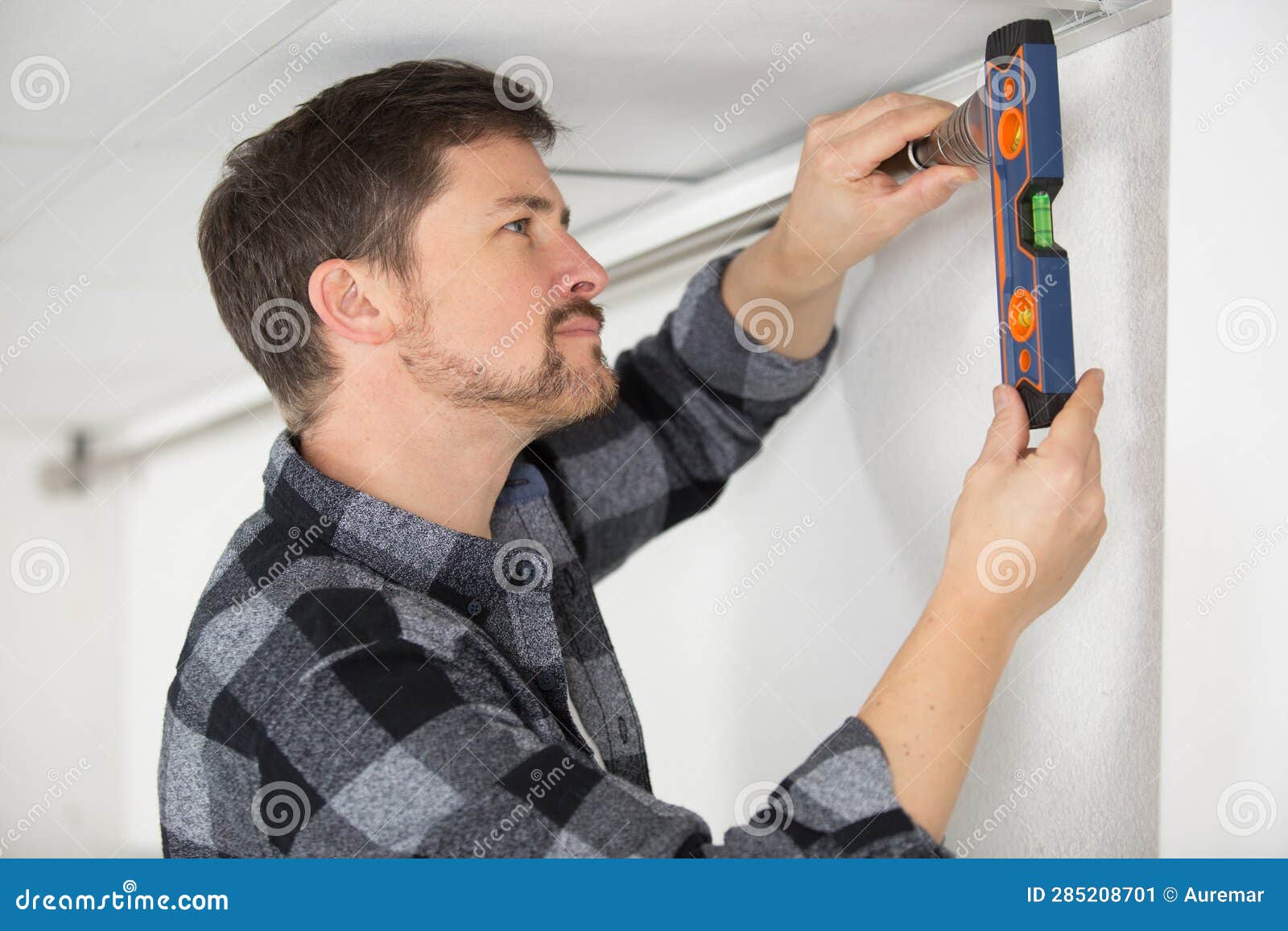 Man Checking Installation with Level on Wall Stock Image - Image of ...