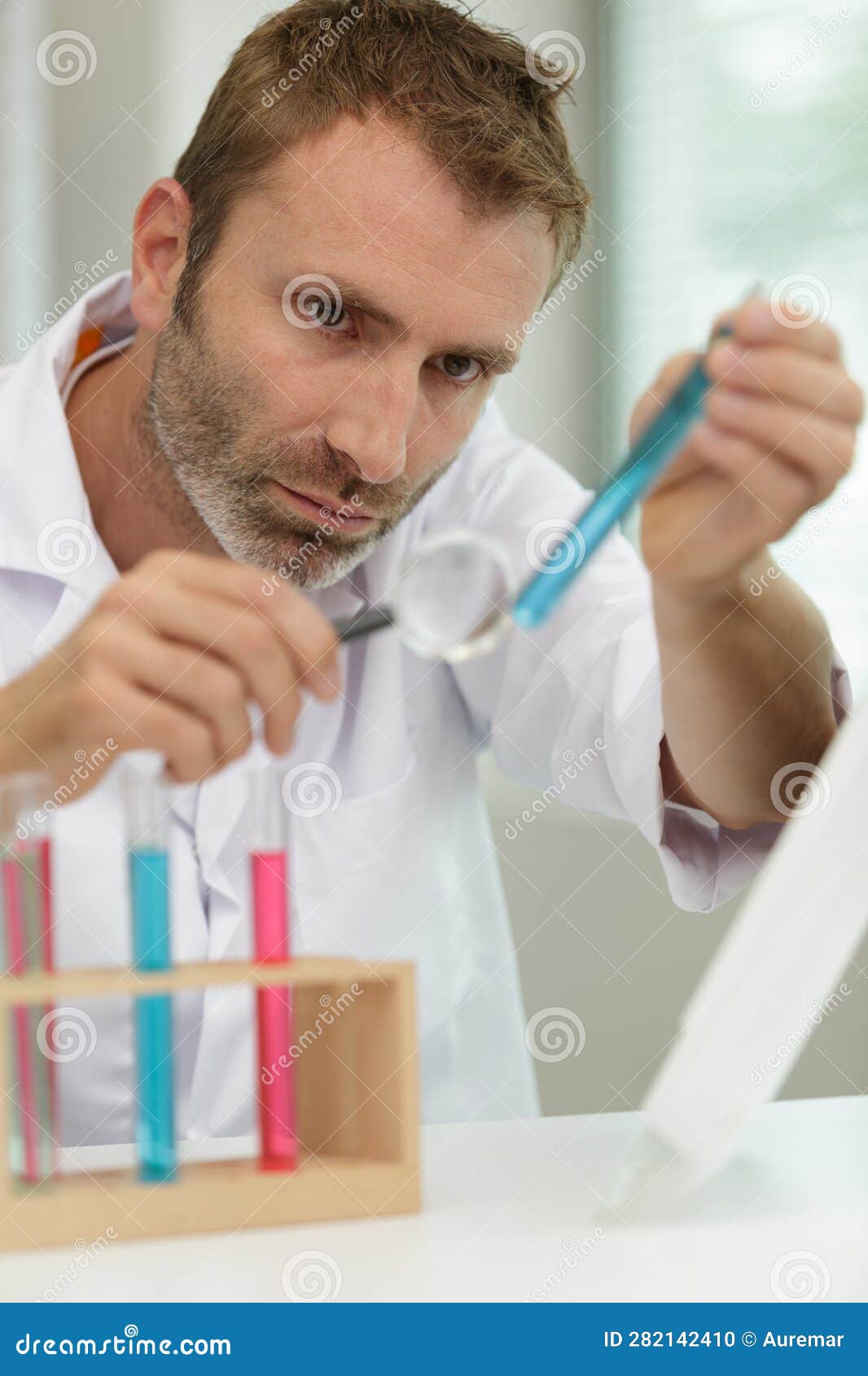 Man Checking Liquid through Magnifying Glass Stock Photo - Image of ...