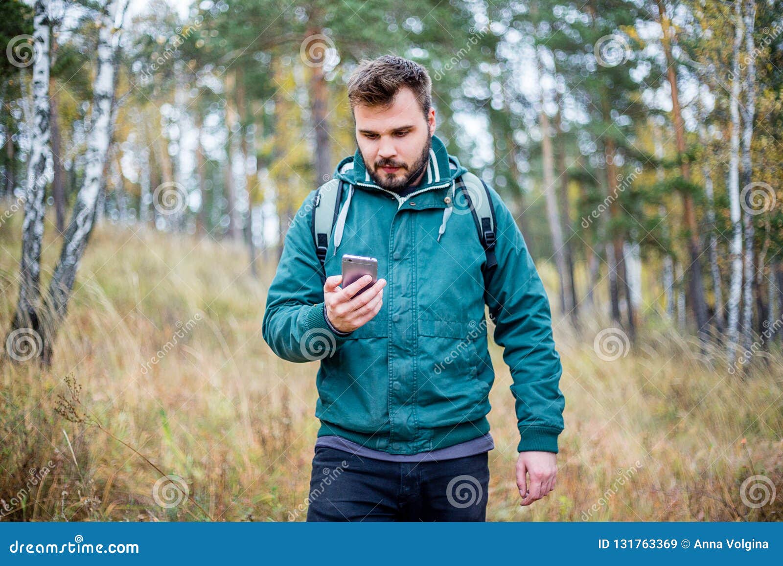Man Checking Map on Phone while Hiking in a Forest Stock Image - Image ...