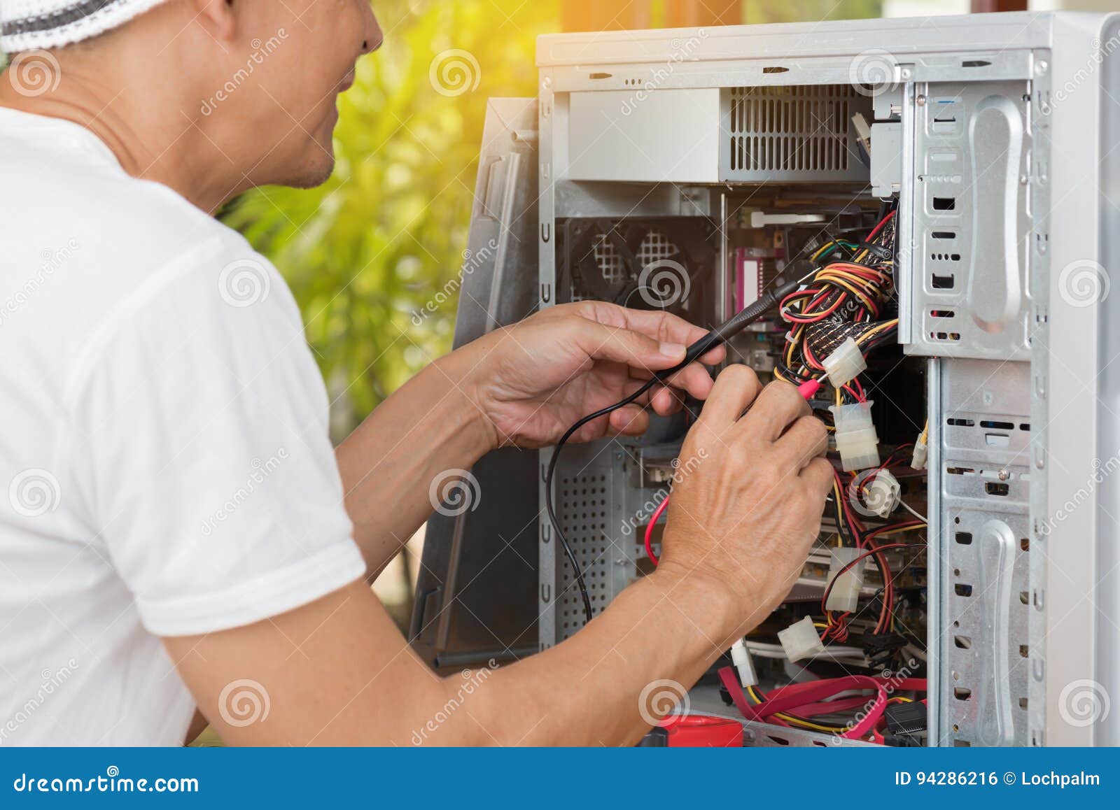 Man Checking Power Signal of Tower PC with Meter Probes of Digital ...
