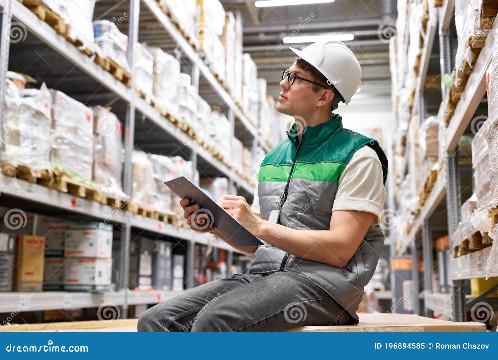 Man is Checking Supplies on Document with an Engrossed Expression in ...