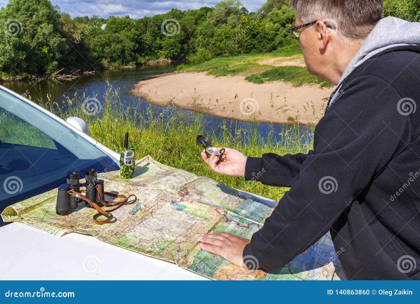 A Man Checking the Terrain on a Map with a Compass Stock Photo - Image ...