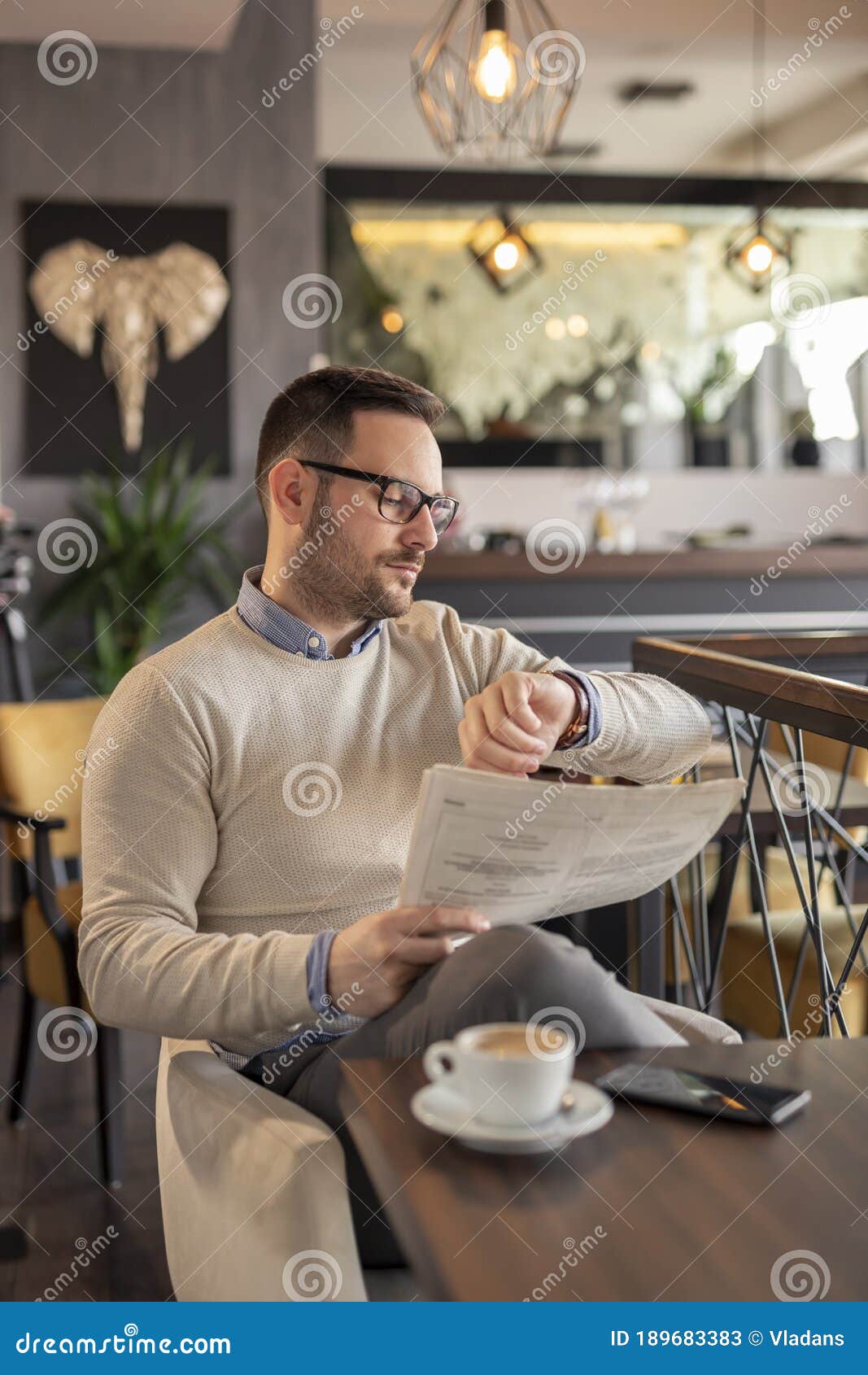 Man Checking the Time while Reading Newspapers Stock Image - Image of ...