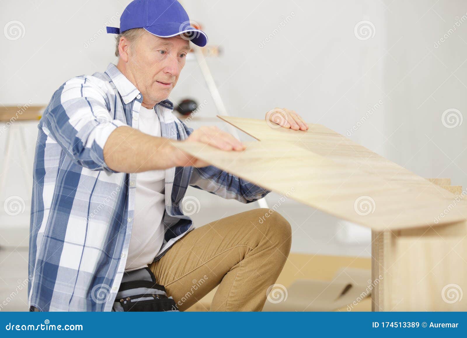 Man checking wood planks stock image. Image of business - 174513389